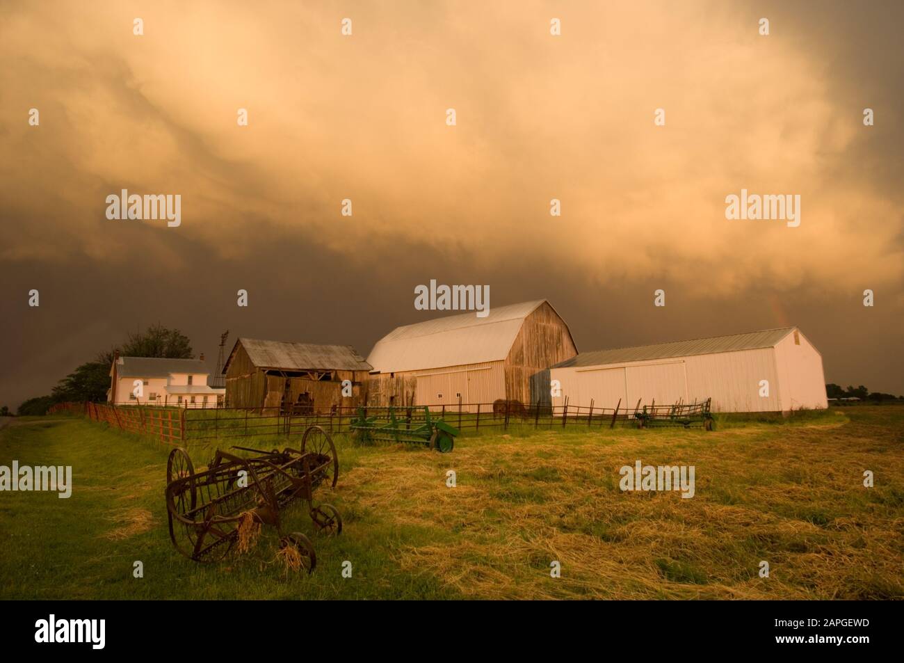 Farm with old barns surrounded by the lawn under a cloudy sky during ...