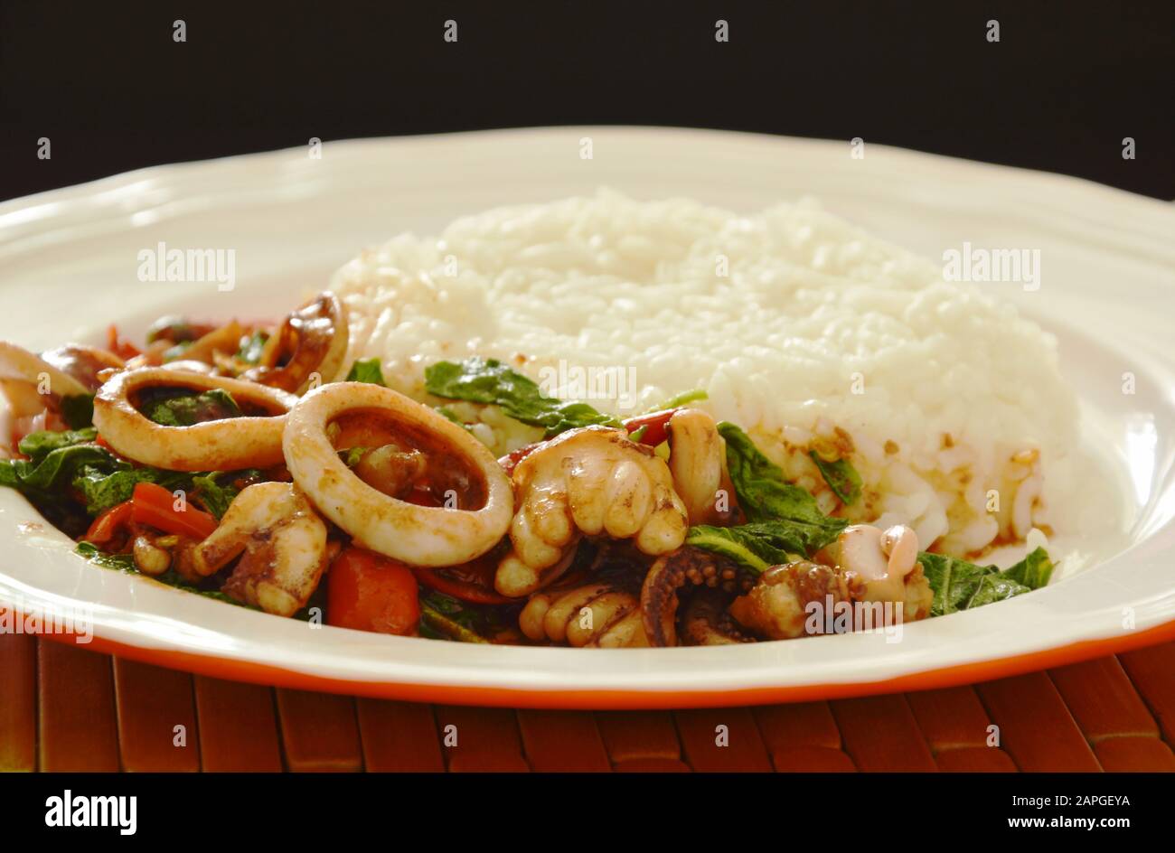 spicy stir fried squid with basil leaf and plain rice Stock Photo - Alamy