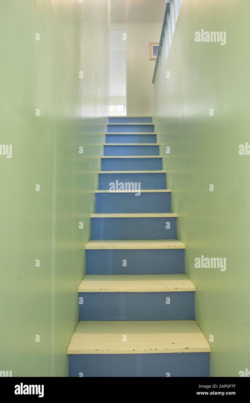 Vertical picture of blue and yellow stairs in a building under the ...