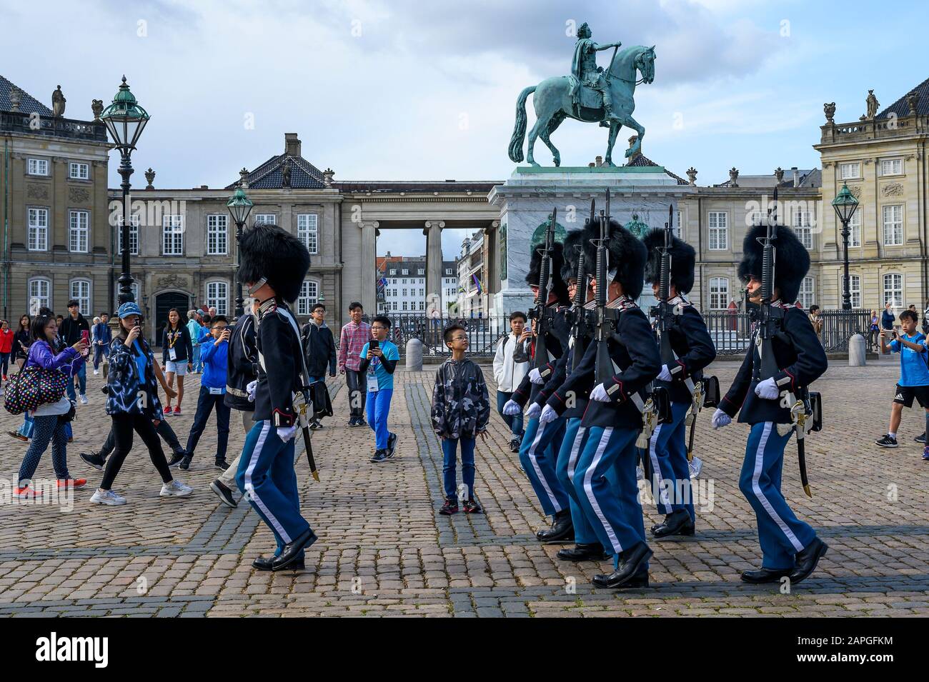 Tourists watch Changing of the Guard at the Royal Amalienborg Palace, Copenhagen, Denmark Stock ...