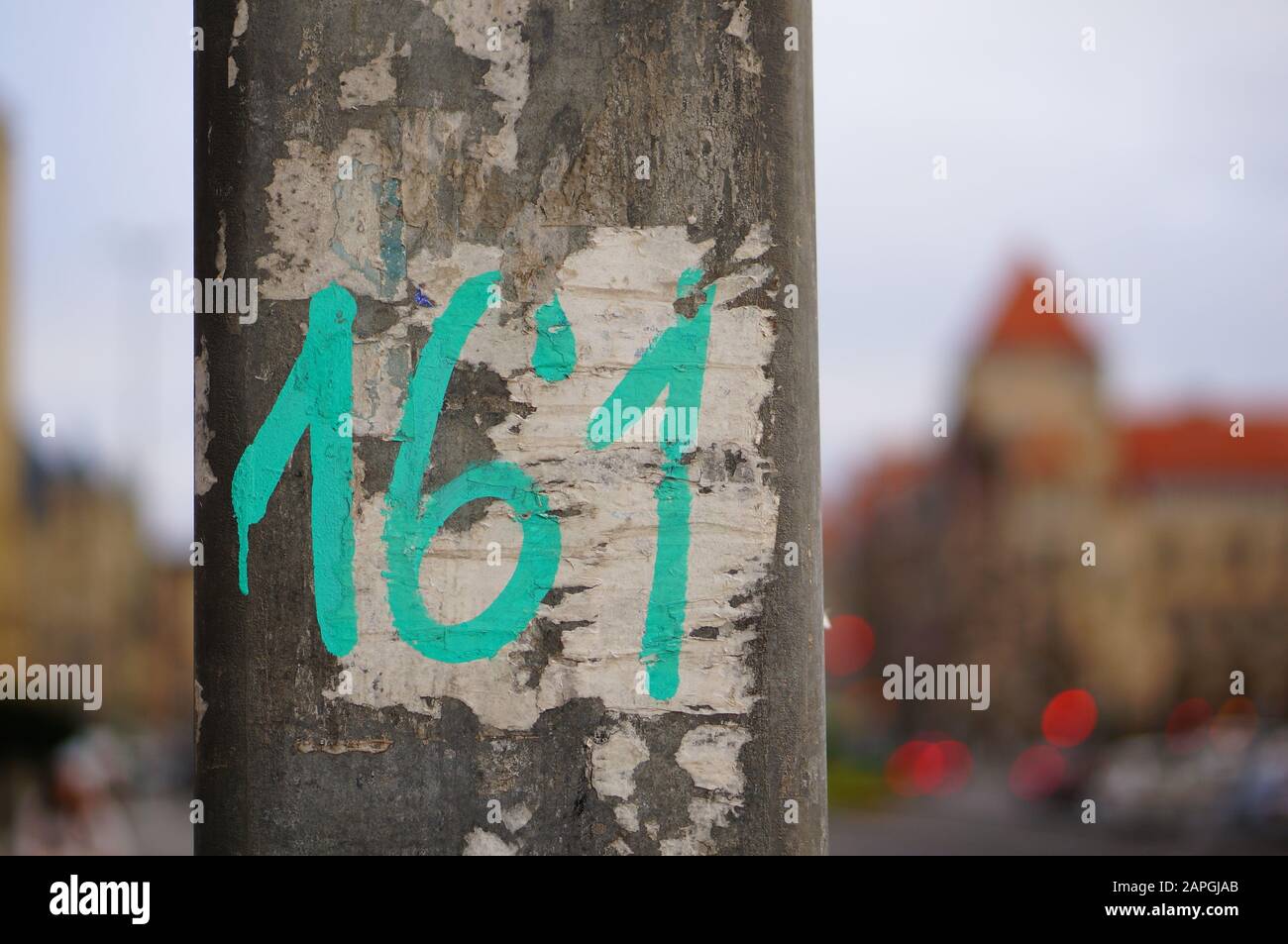 Closeup shot of a concrete pole with number sprayed on it Stock Photo ...