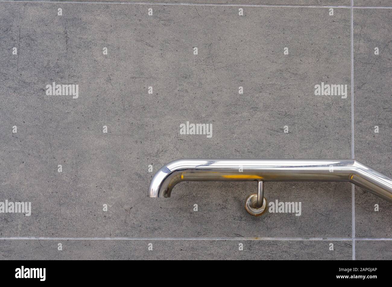 Metal stair handle attached to a wall Stock Photo - Alamy