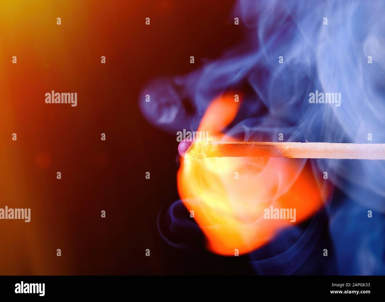 Burning match with blue smoke over black background Stock Photo - Alamy