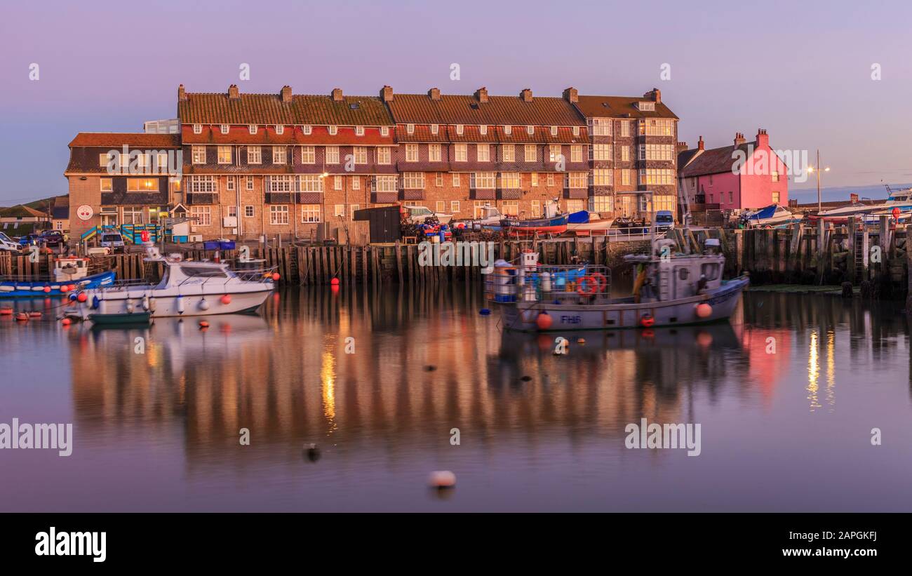 west bay harbour at dusk into night, seaside town, dorset, england, uk ...