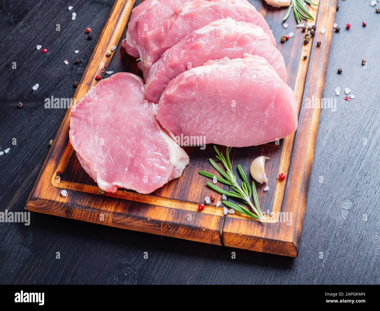Pork steak, raw carbonate fillet on dark background, meat with rosemary ...