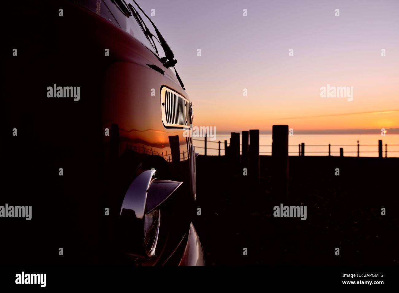 A parked VW Volkswagen campervan at sunrise / sunset. Hastings, East ...