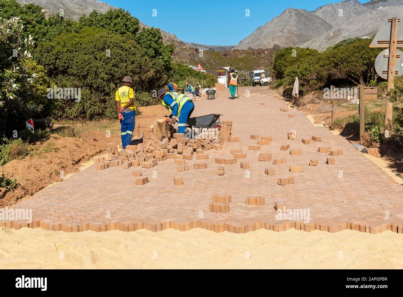 Rooiels, Western Cape, South Africa. December 2019. Workers laying a ...