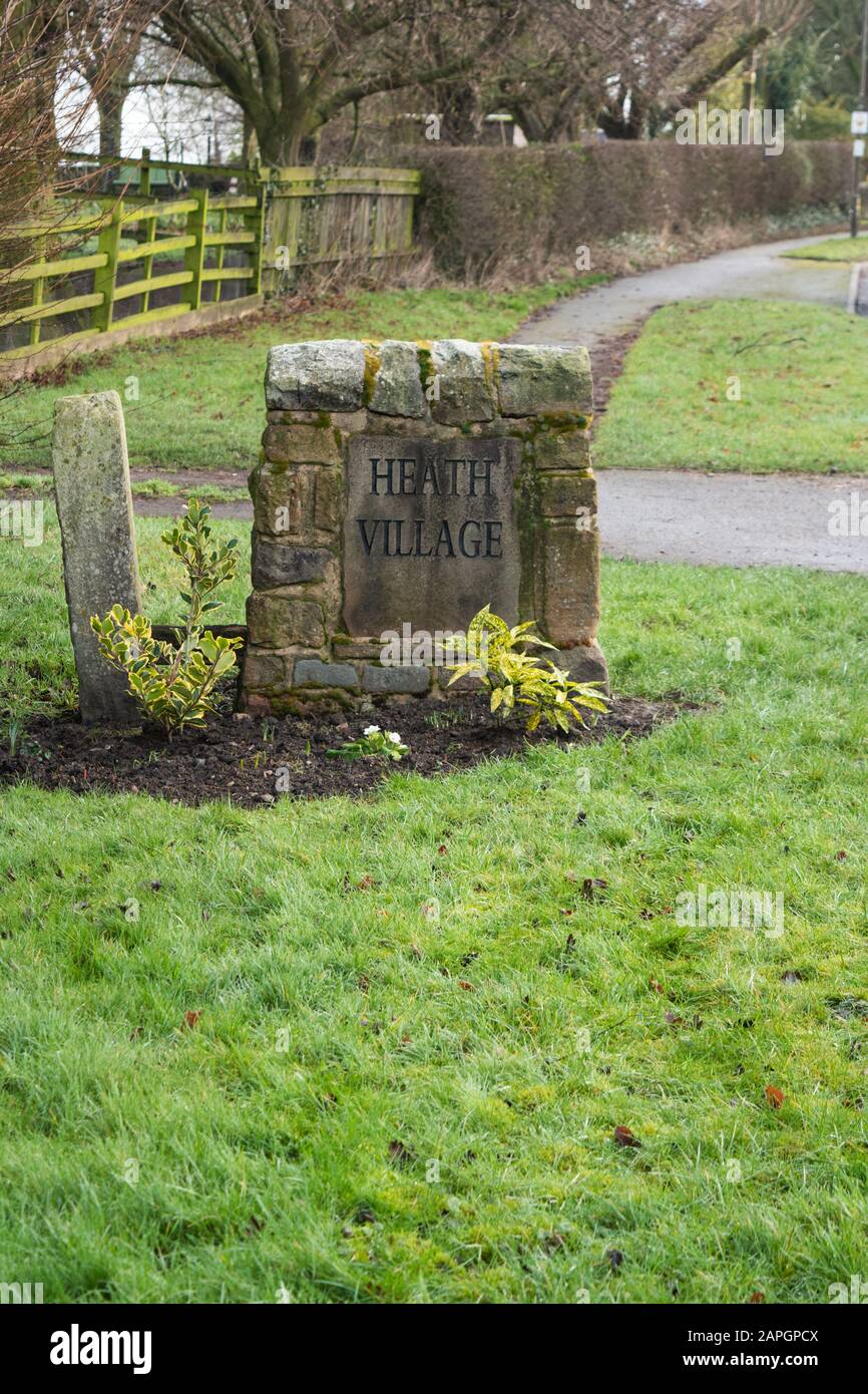 Stone built welcome sign to the conservation village of Heath Village ...