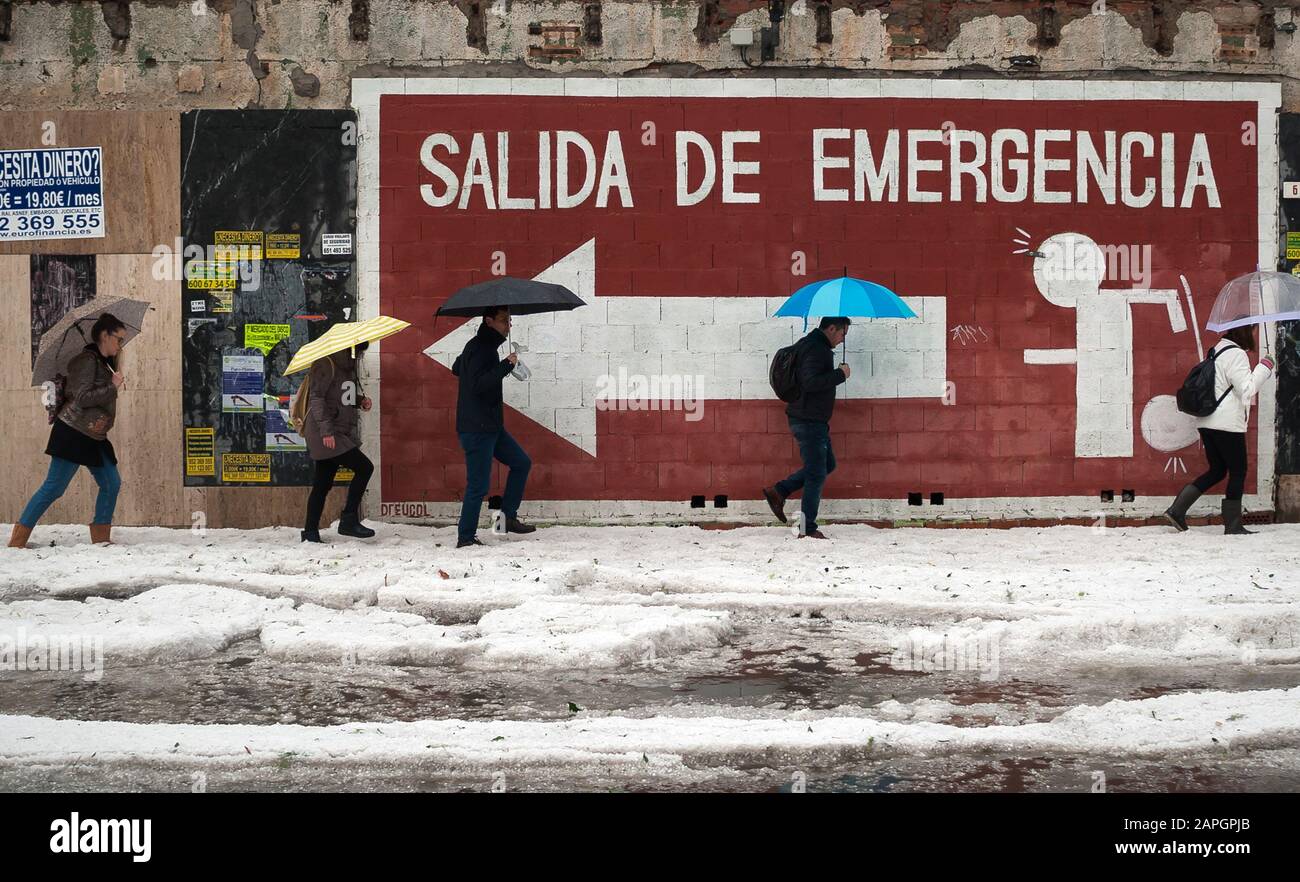 People walk on hail while holding umbrellas after a heavy hailstorm in ...