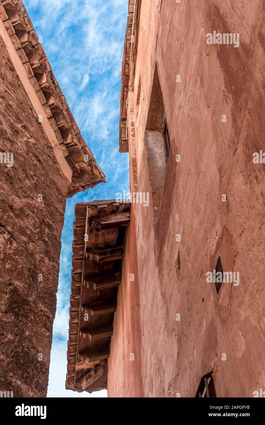Medieval wooden soffit with rafters and frieze on a house made of red ...
