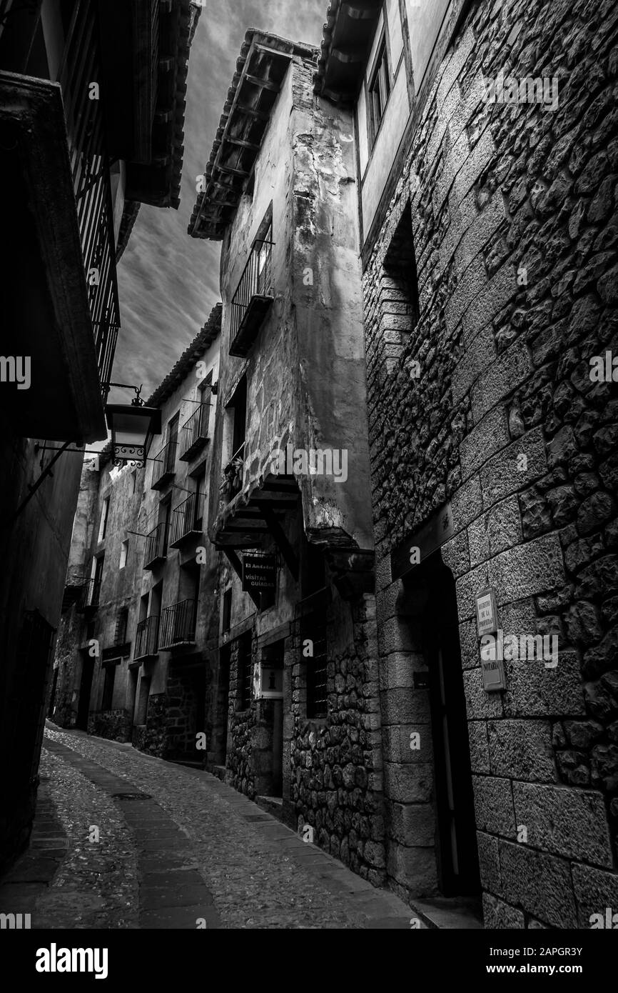 Narrow medieval alley way with passage made of terracotta red stone in ...