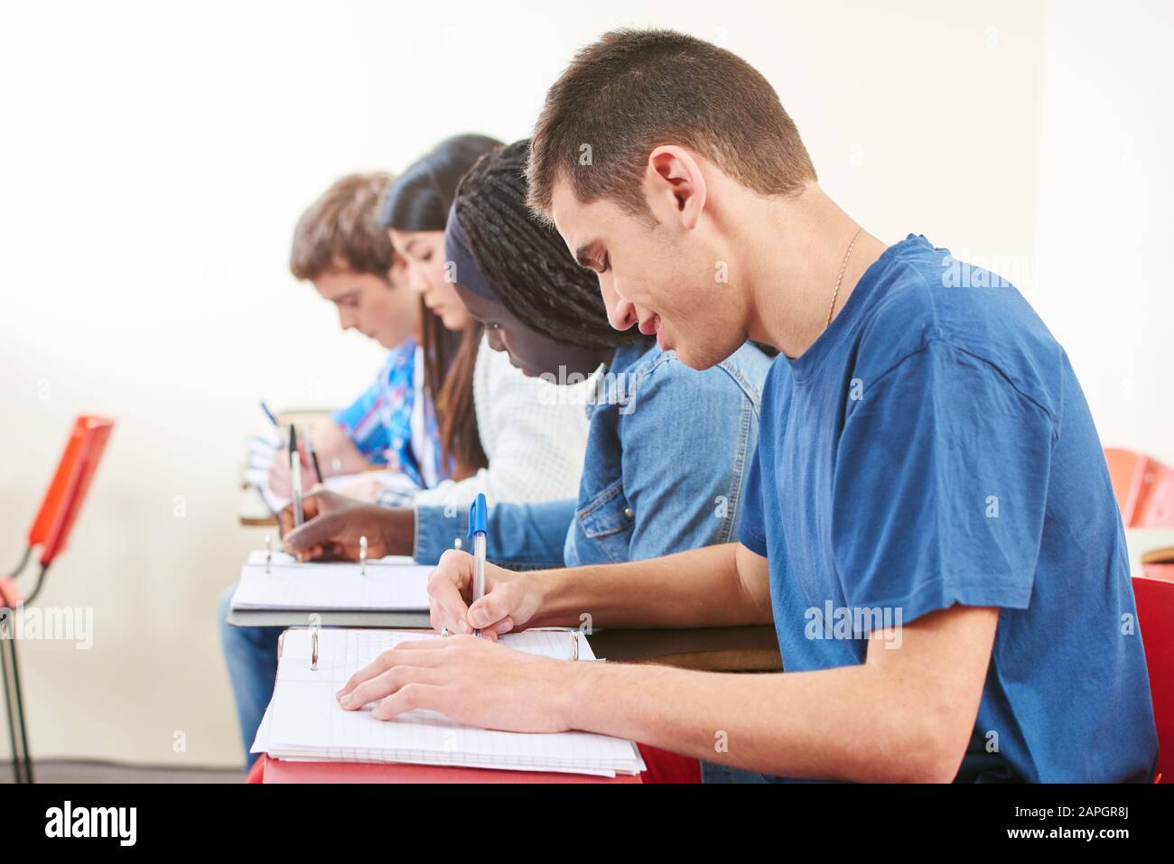 Students writing in class in a high school Stock Photo - Alamy