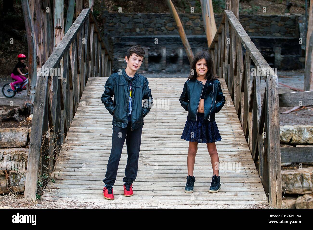 Cute boy and girl dressed and posing with black leather Stock Photo - Alamy