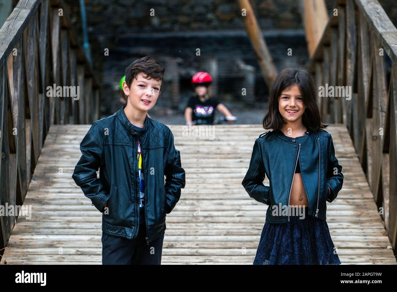 Cute boy and girl dressed and posing with black leather Stock Photo - Alamy