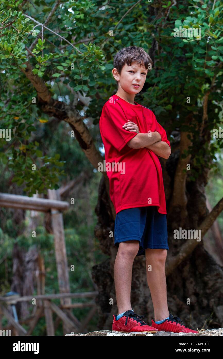 Cute boy dressed and posing with sport clothing Stock Photo - Alamy