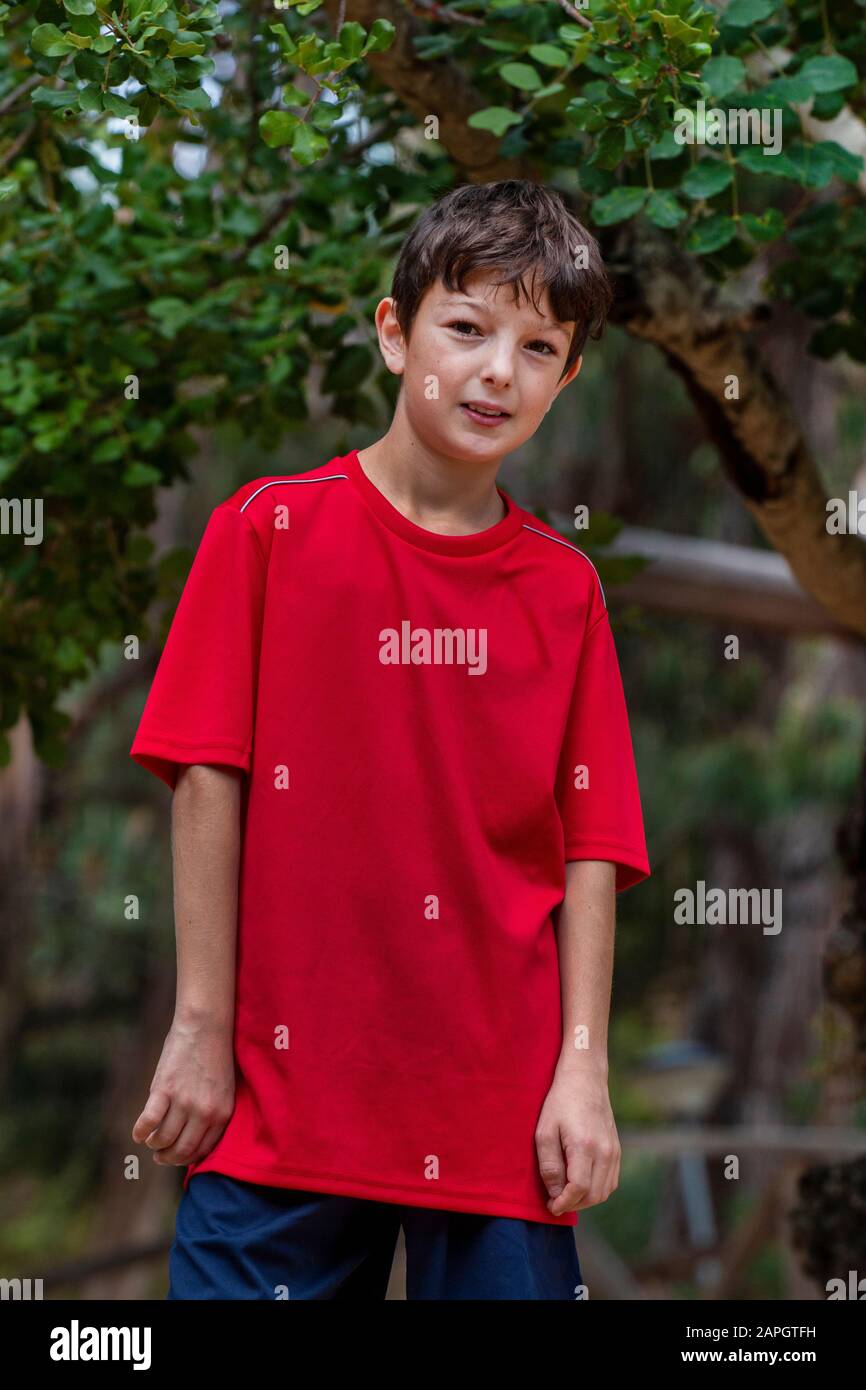 Cute boy dressed and posing with sport clothing Stock Photo - Alamy