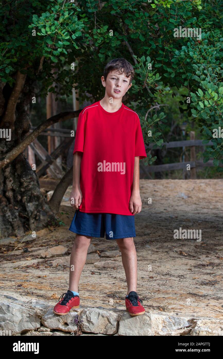 Cute boy dressed and posing with sport clothing Stock Photo - Alamy