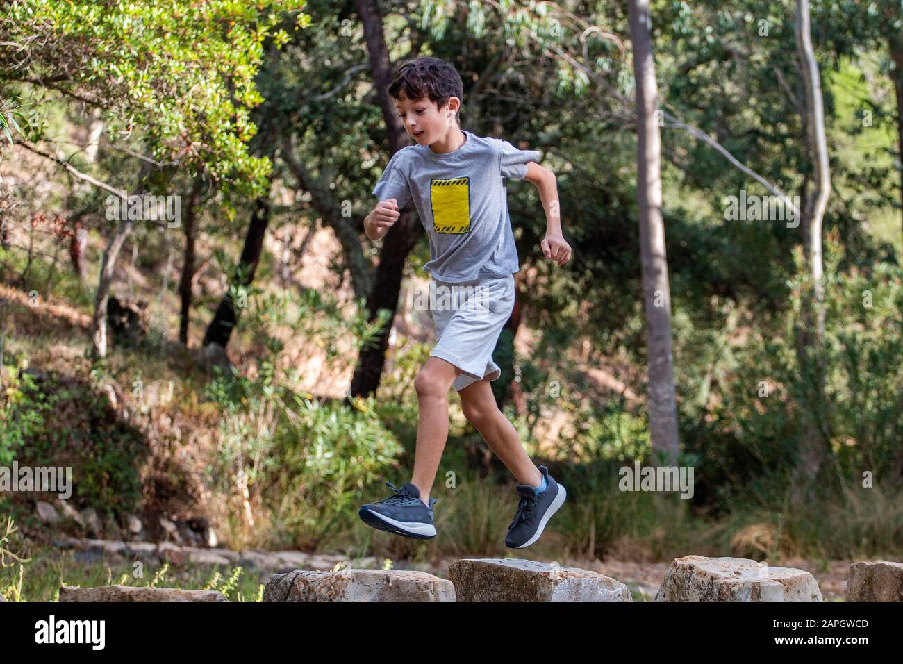 Cute boy in sport clothing running Stock Photo - Alamy