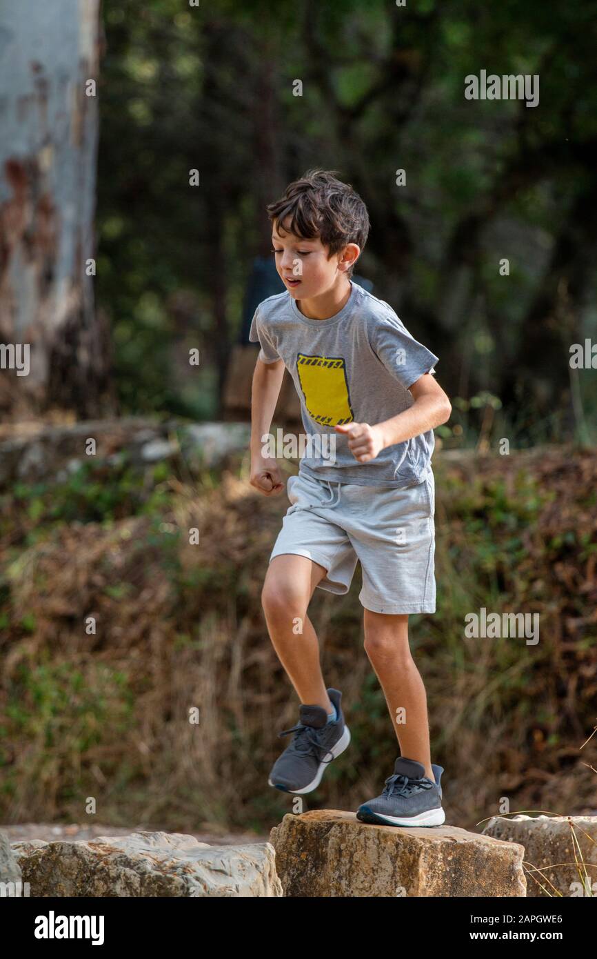 Cute boy in sport clothing running Stock Photo - Alamy