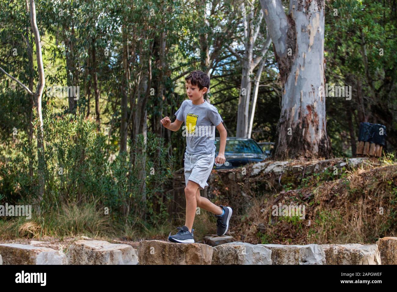 Cute boy in sport clothing running Stock Photo - Alamy