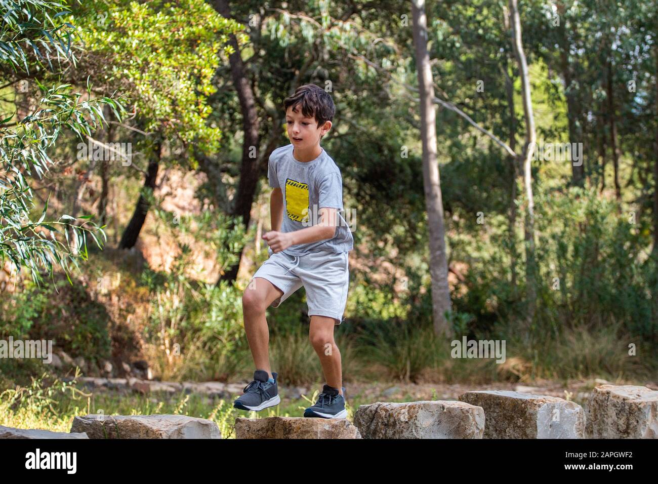 Cute boy in sport clothing running Stock Photo - Alamy