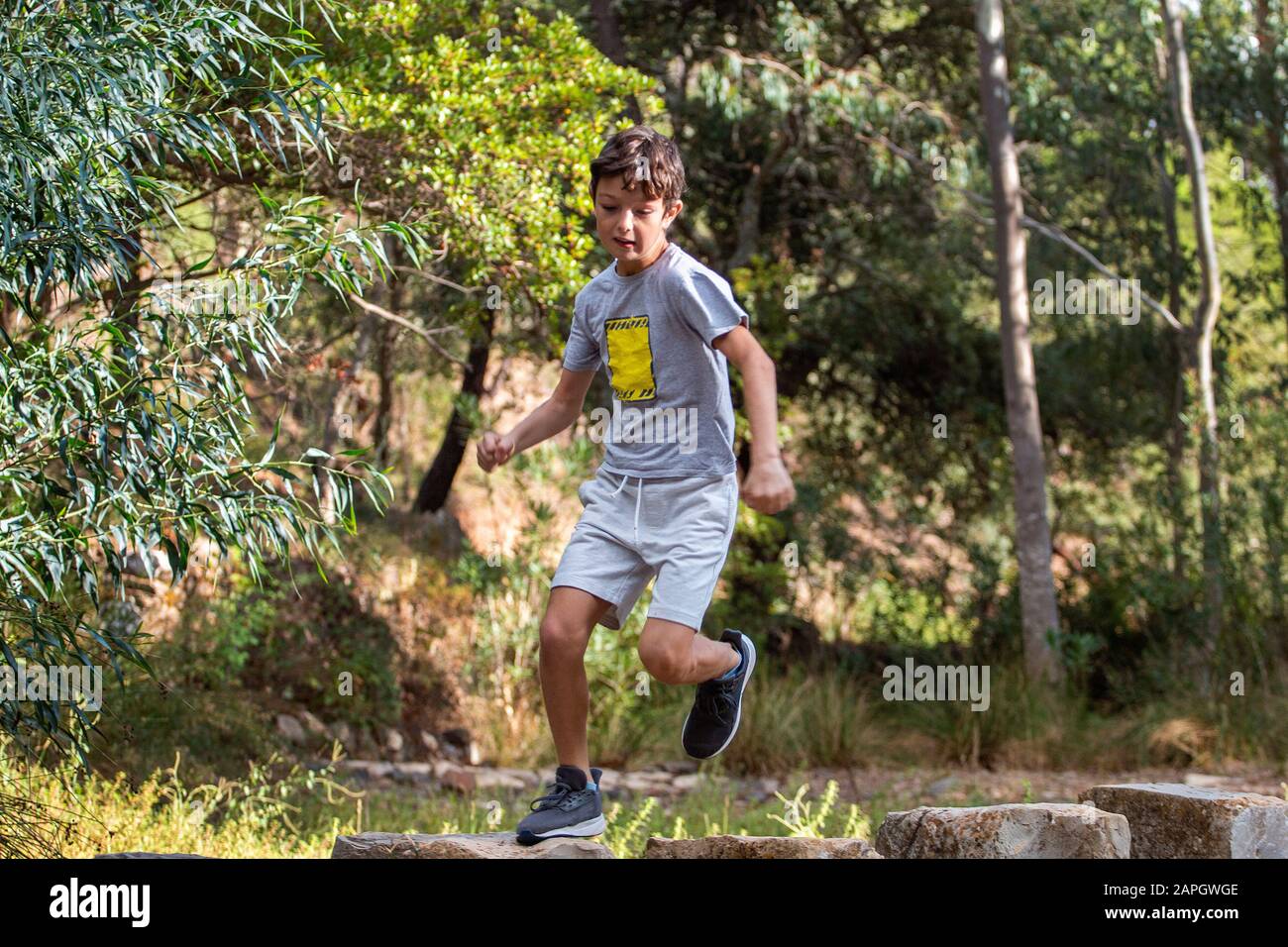 Cute boy in sport clothing running Stock Photo - Alamy