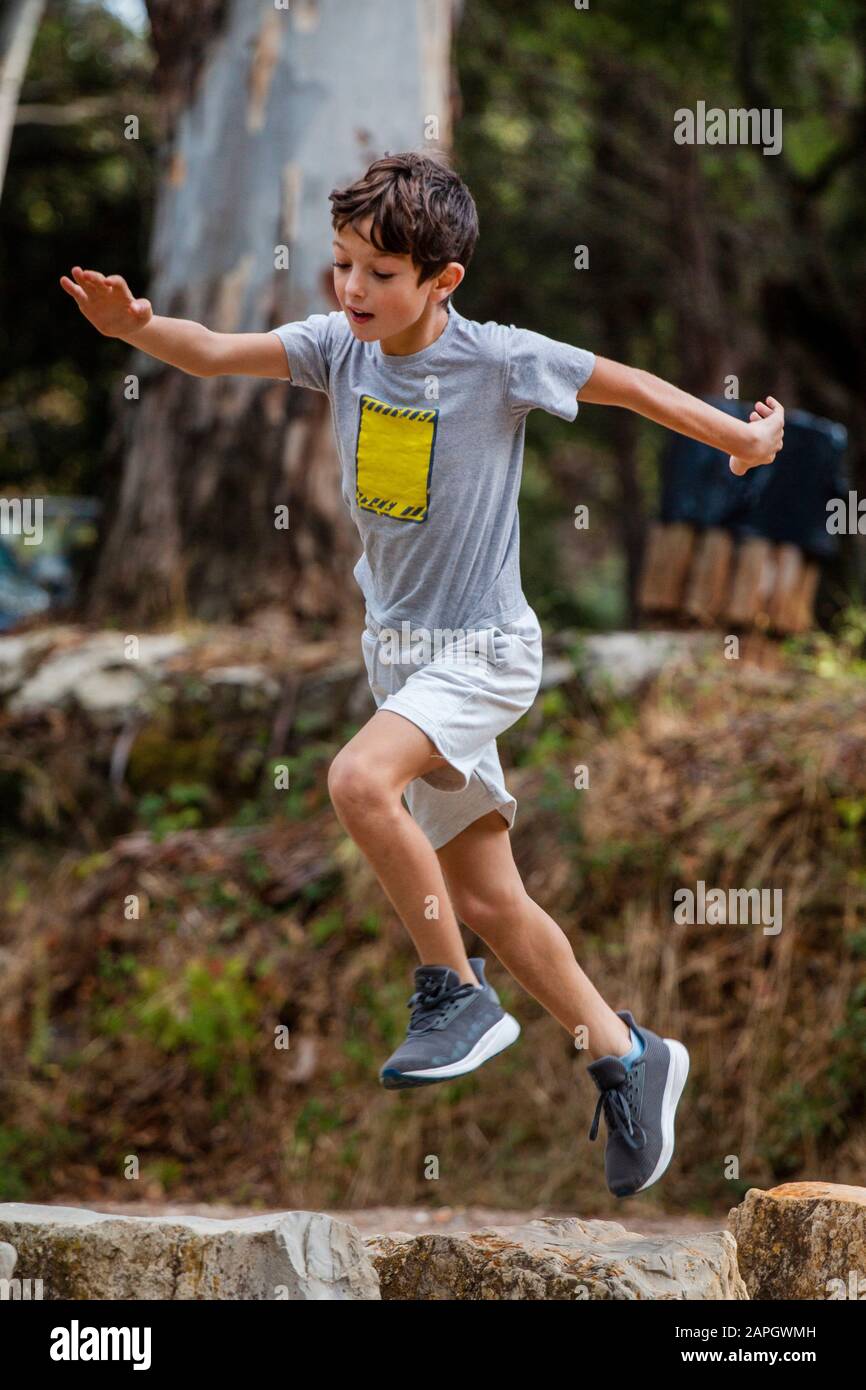 Cute boy in sport clothing running Stock Photo - Alamy