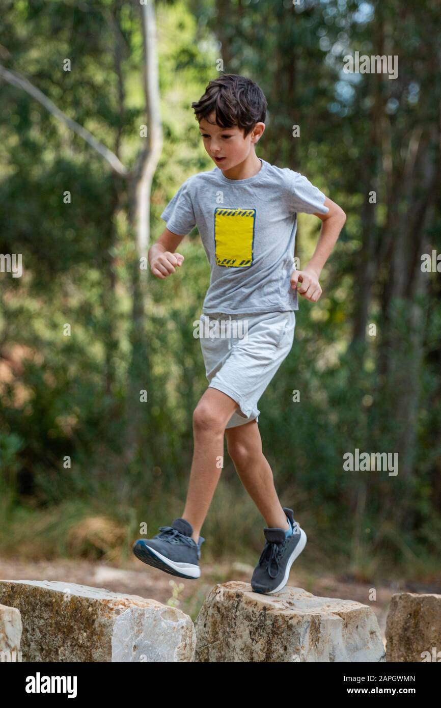 Cute boy in sport clothing running Stock Photo - Alamy