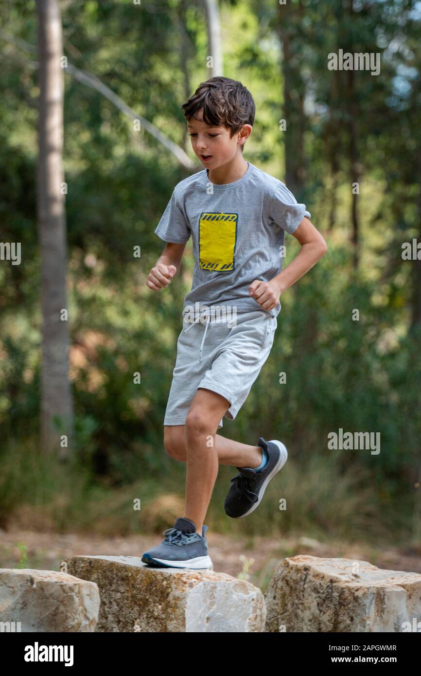 Cute boy in sport clothing running Stock Photo - Alamy