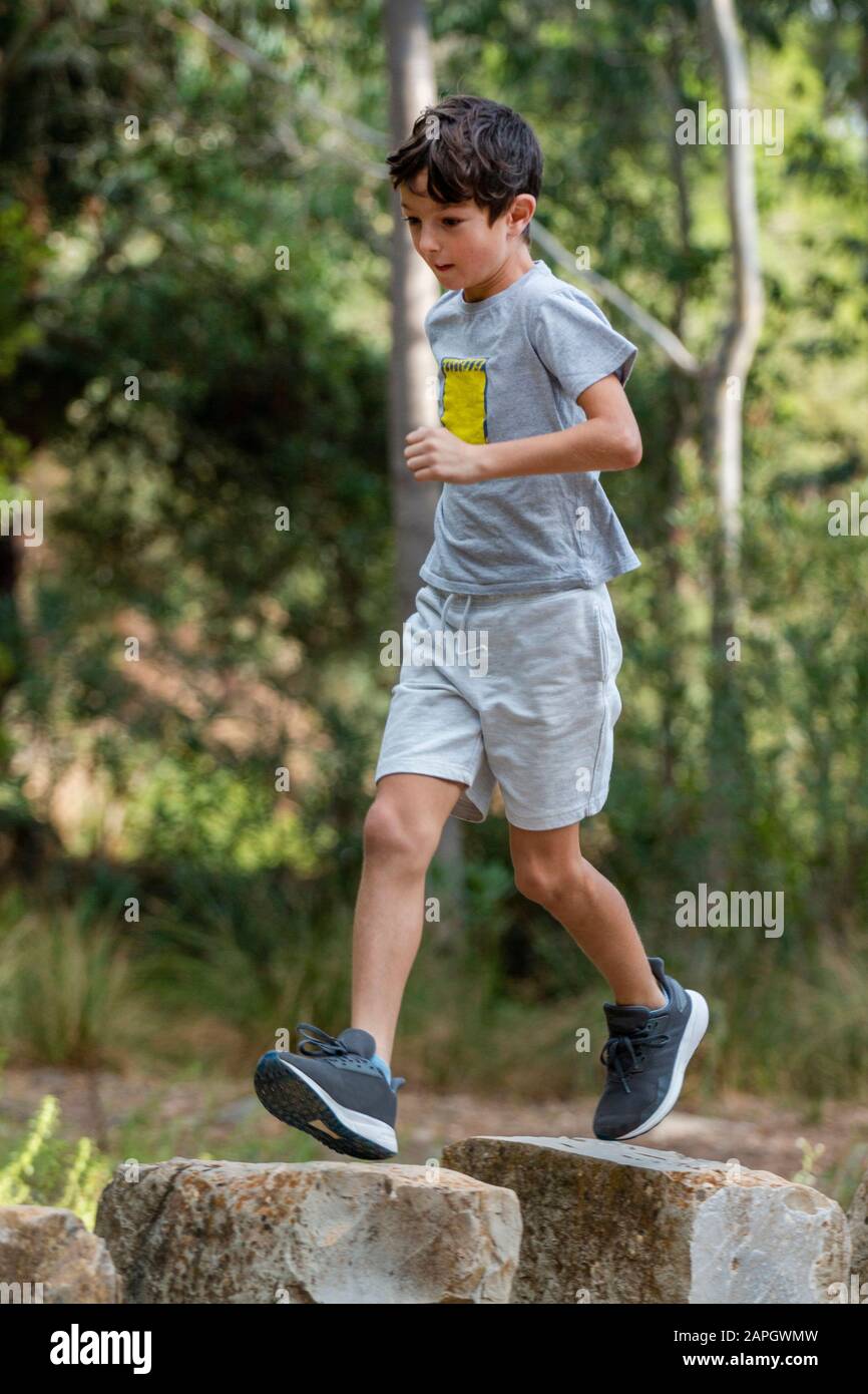 Cute boy in sport clothing running Stock Photo - Alamy
