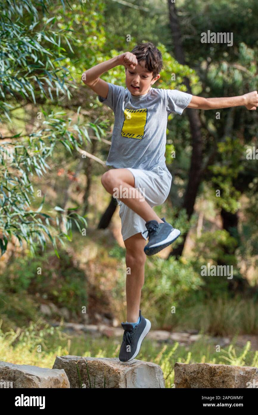 Cute boy in sport clothing running Stock Photo - Alamy
