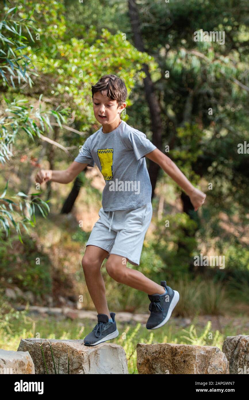 Cute boy in sport clothing running Stock Photo - Alamy
