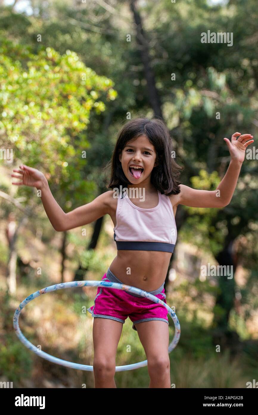 Cute girl with hula hoop posing on the outdoor forest Stock Photo - Alamy