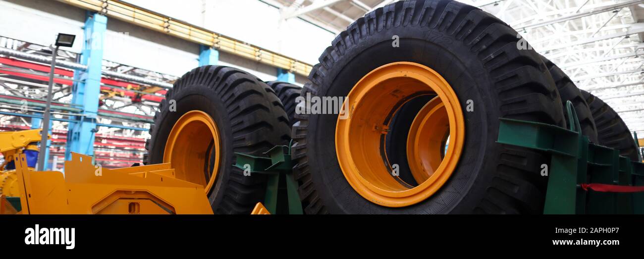 Set of extremely big wheels standing at warehouse Stock Photo - Alamy