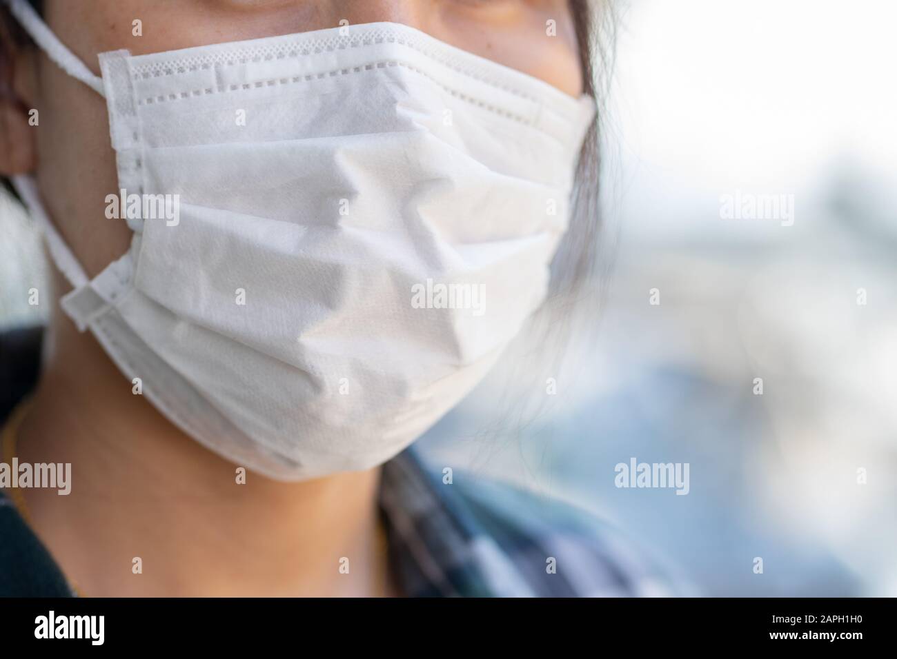 Woman wearing face mask protect filter against air pollution (PM2.5) or ...