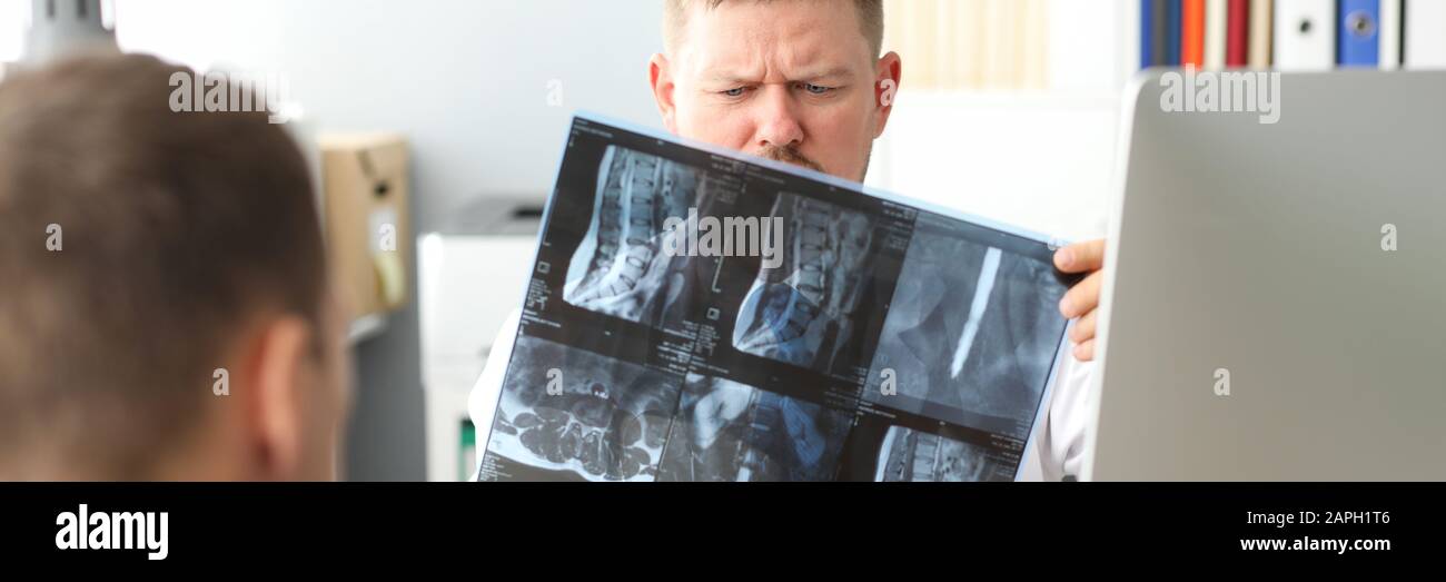 GP examining CT scan detecting problem at office workplace Stock Photo ...