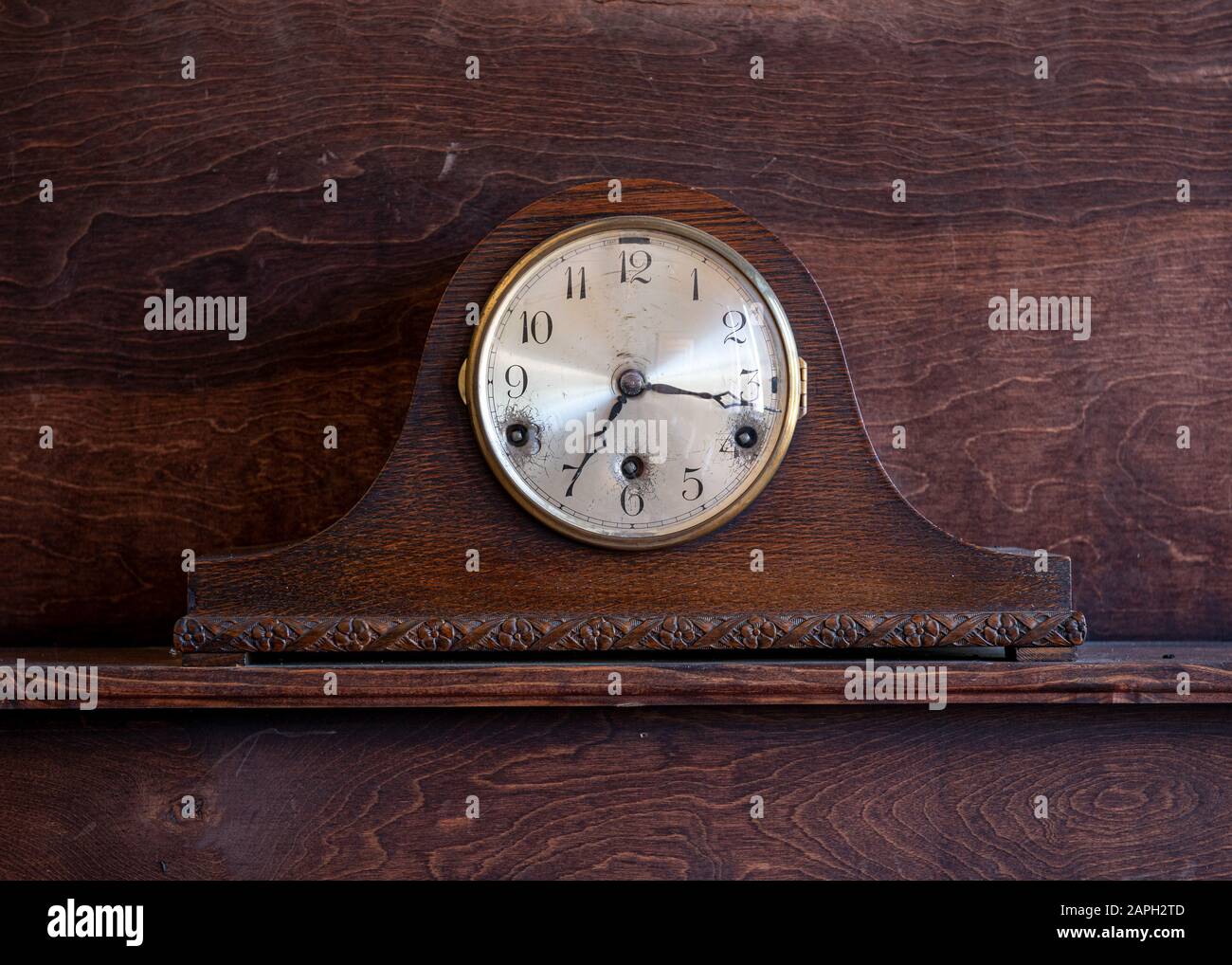 Closeup on the pointers of a clock marking ten minutes before nine o ...