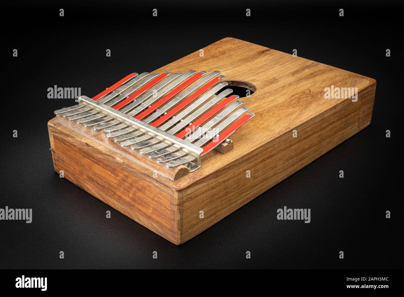 Details of a thumb piano (Kalimba, Mbira) with silver and red tines ...