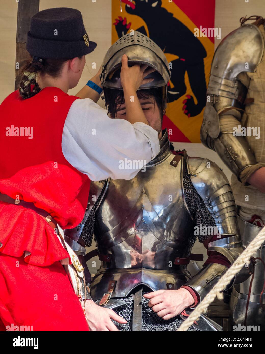 VYBORG, RUSSIA - JULY 27: A squire helps a knight take off his helmet ...