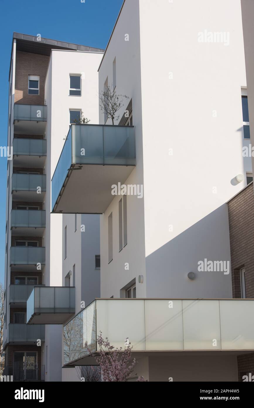 Modern concrete balcony s in a cut out on blue sky Stock Photo - Alamy