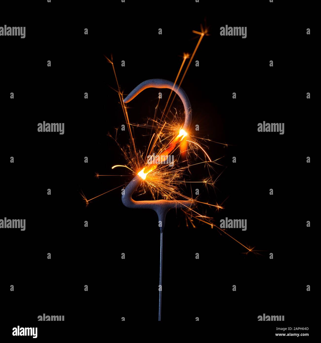 Burning sparkler in shape of number two, digit 2, isolated on black ...
