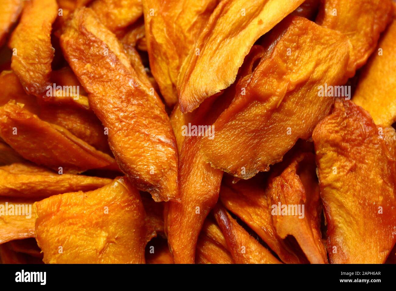 The picture shows dried mango slices Stock Photo - Alamy