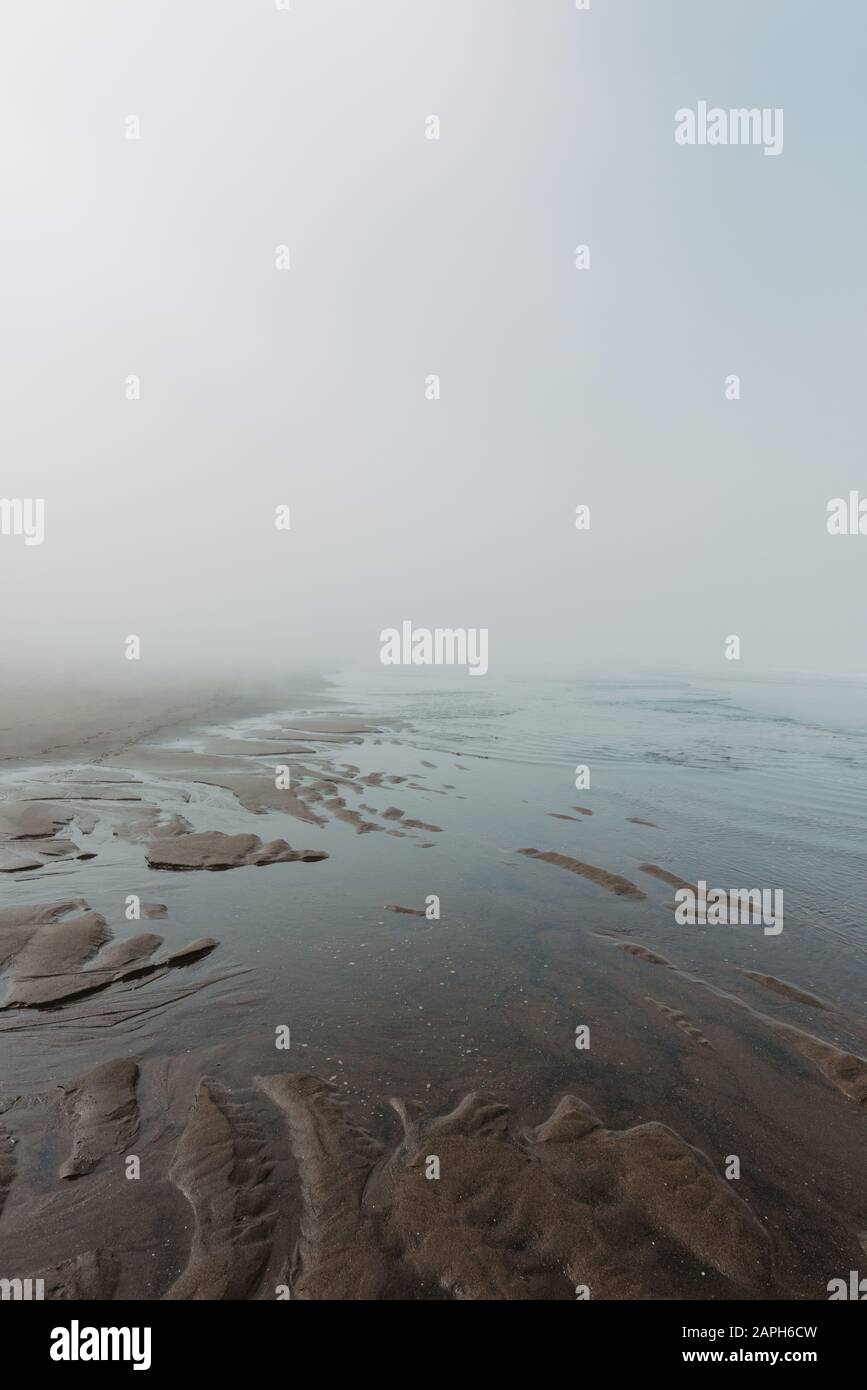 Ocean beach in dense fog during ebb Stock Photo - Alamy