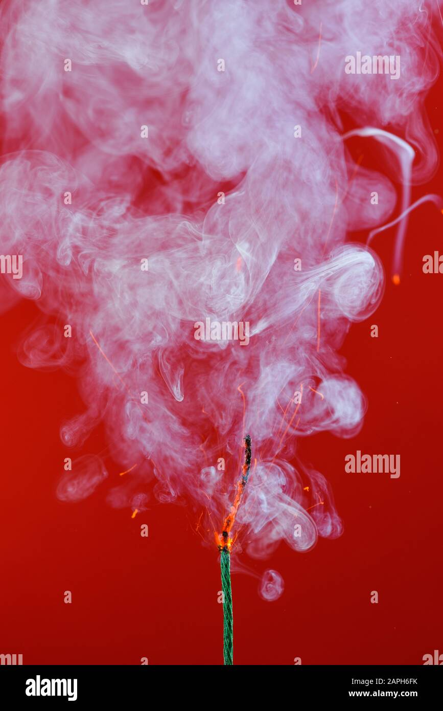 Burning fuse wick cord with sparks and smoke on red background Stock ...