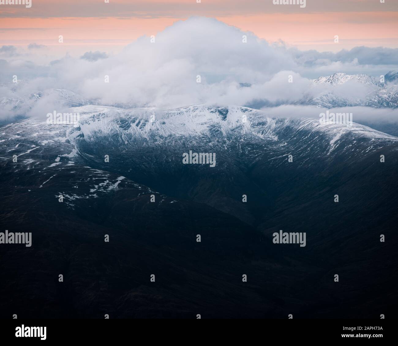 Beautiful landscape view of snowy Ben Nevis with dramatic clouds above ...