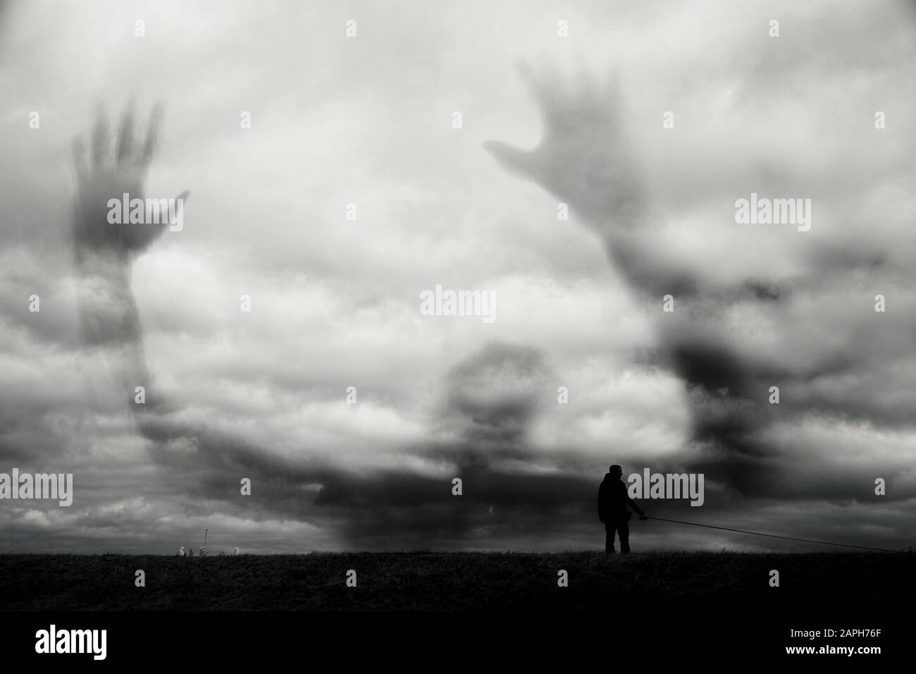Large ghost figure in the background of clouds Stock Photo - Alamy