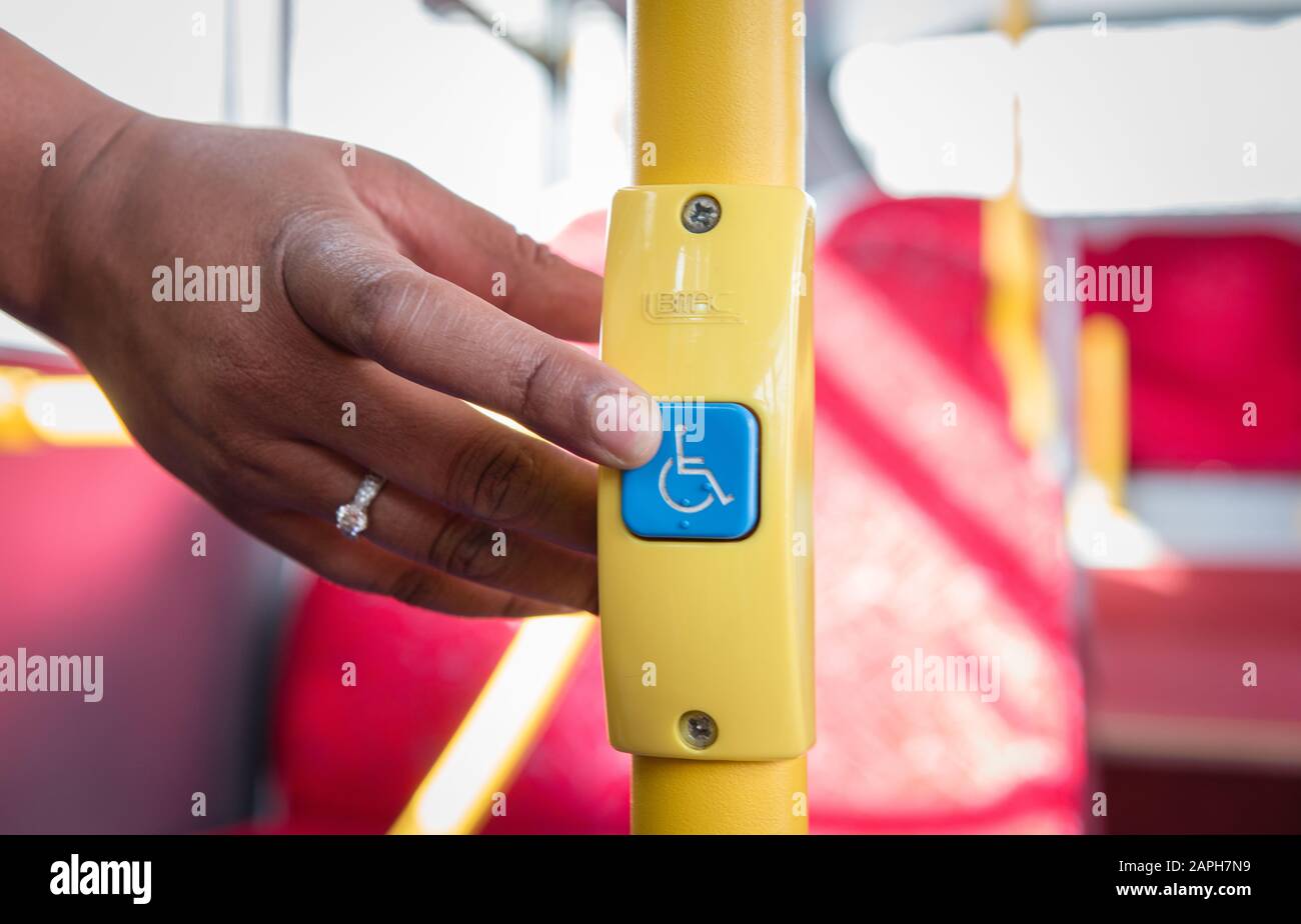 Pressing the wheelchair stop button on a London bus Stock Photo - Alamy