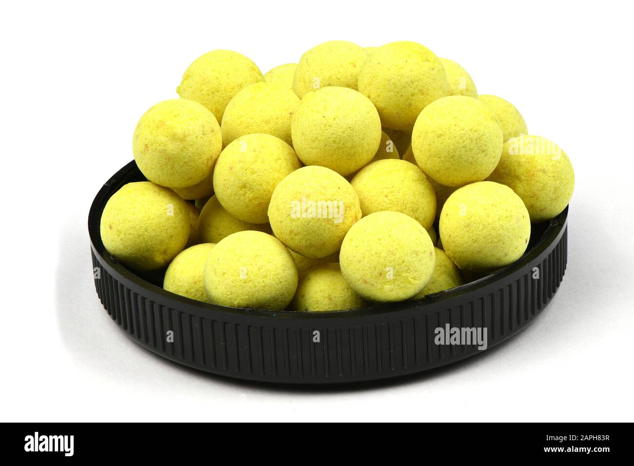Bowl full of yellow boilies, fishing baits for carp, isolated on white ...