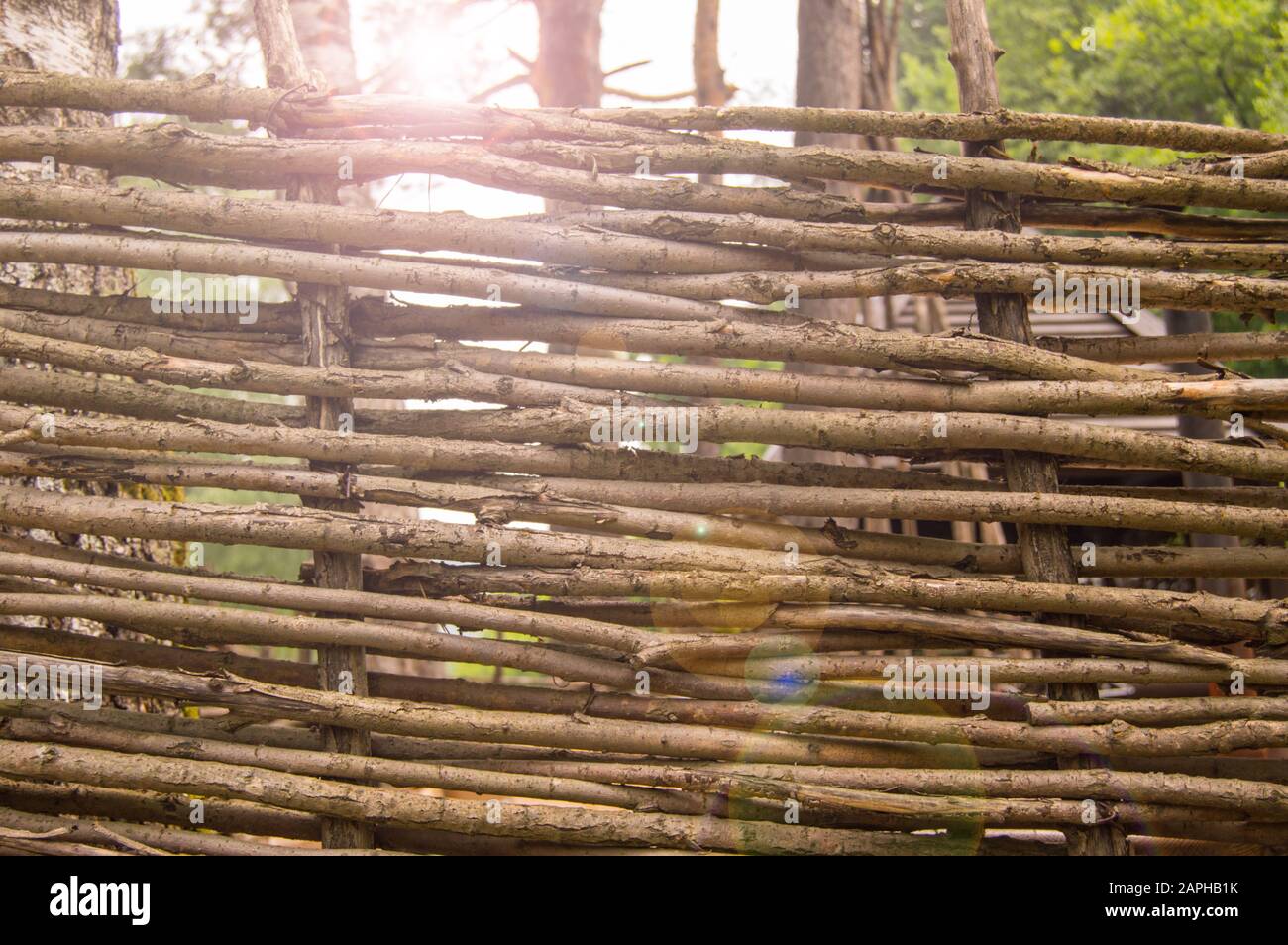 Old wicker rustic fence made of long poles, horizontal vintage ...