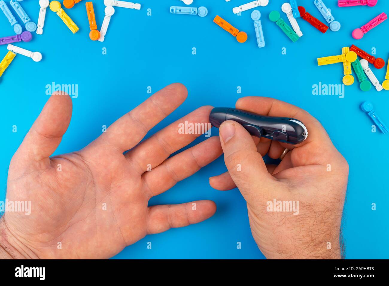 Diabetes test. Man hands checking blood sugar level by Glucose meter on ...